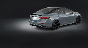Rear angled view of the Sentra Midnight Edition in a virtual gray room ...